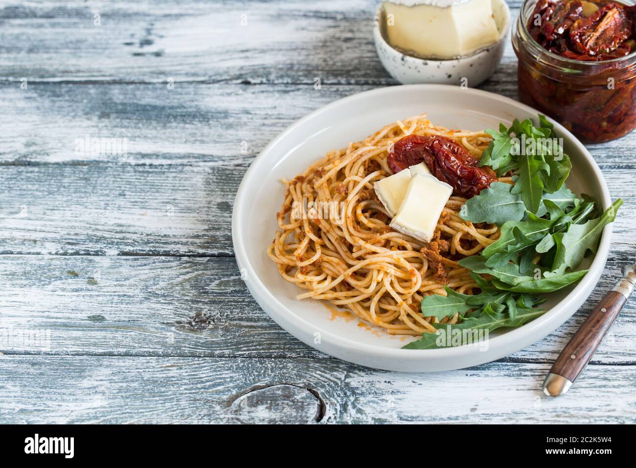 Italian Pasta with sun-dried tomato pesto and brie cheese Stock Photo ...