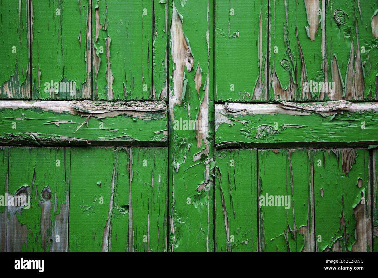 Green painted wooden wall, detail of old spoiled wood, green background ...