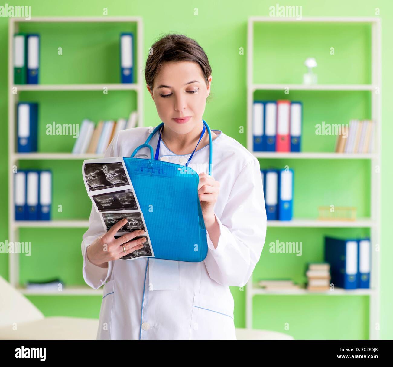 The female doctor gynecologyst writing medical record in the clinic ...