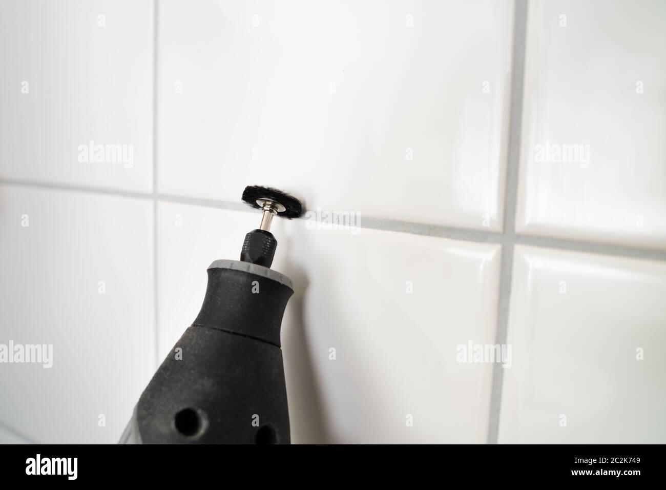 Person Cleaning The Dirty White Tile Of The Wall Using Power Tool Stock ...