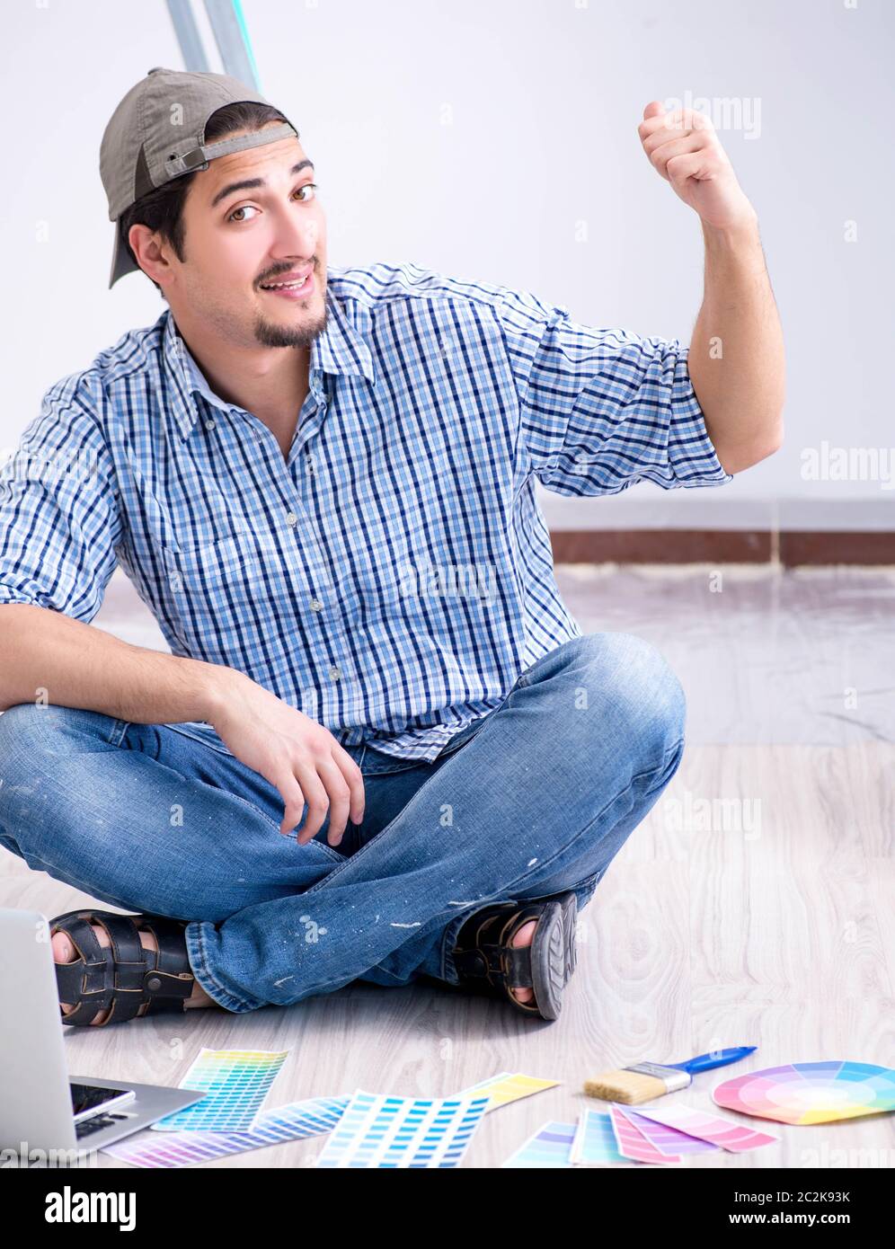 The young man contractor choosing color from rainbow Stock Photo - Alamy