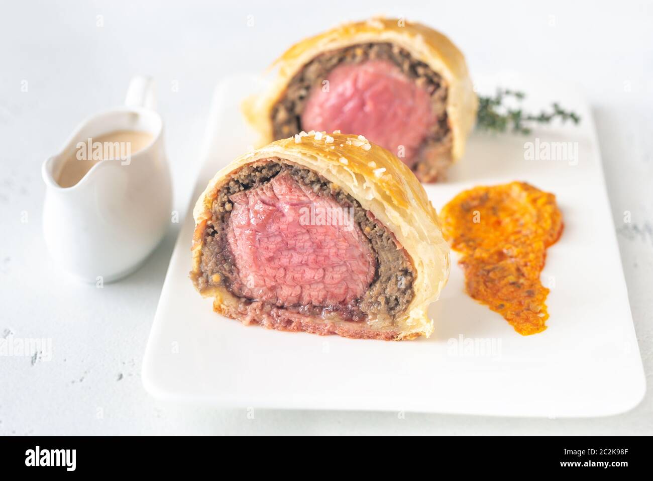 Portion of beef Wellington on the white plate: cross section Stock ...