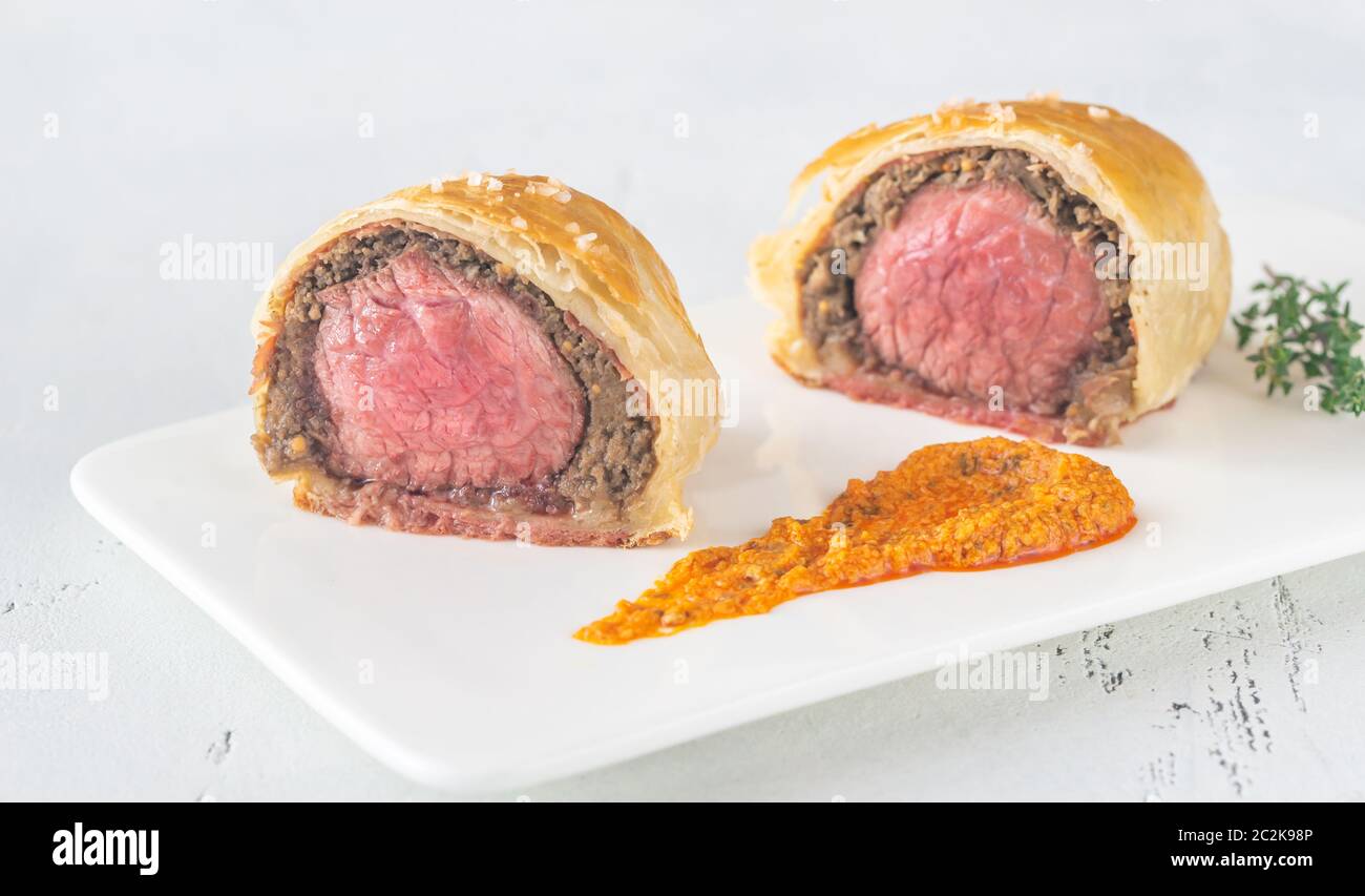 Portion of beef Wellington on the white plate: cross section Stock ...