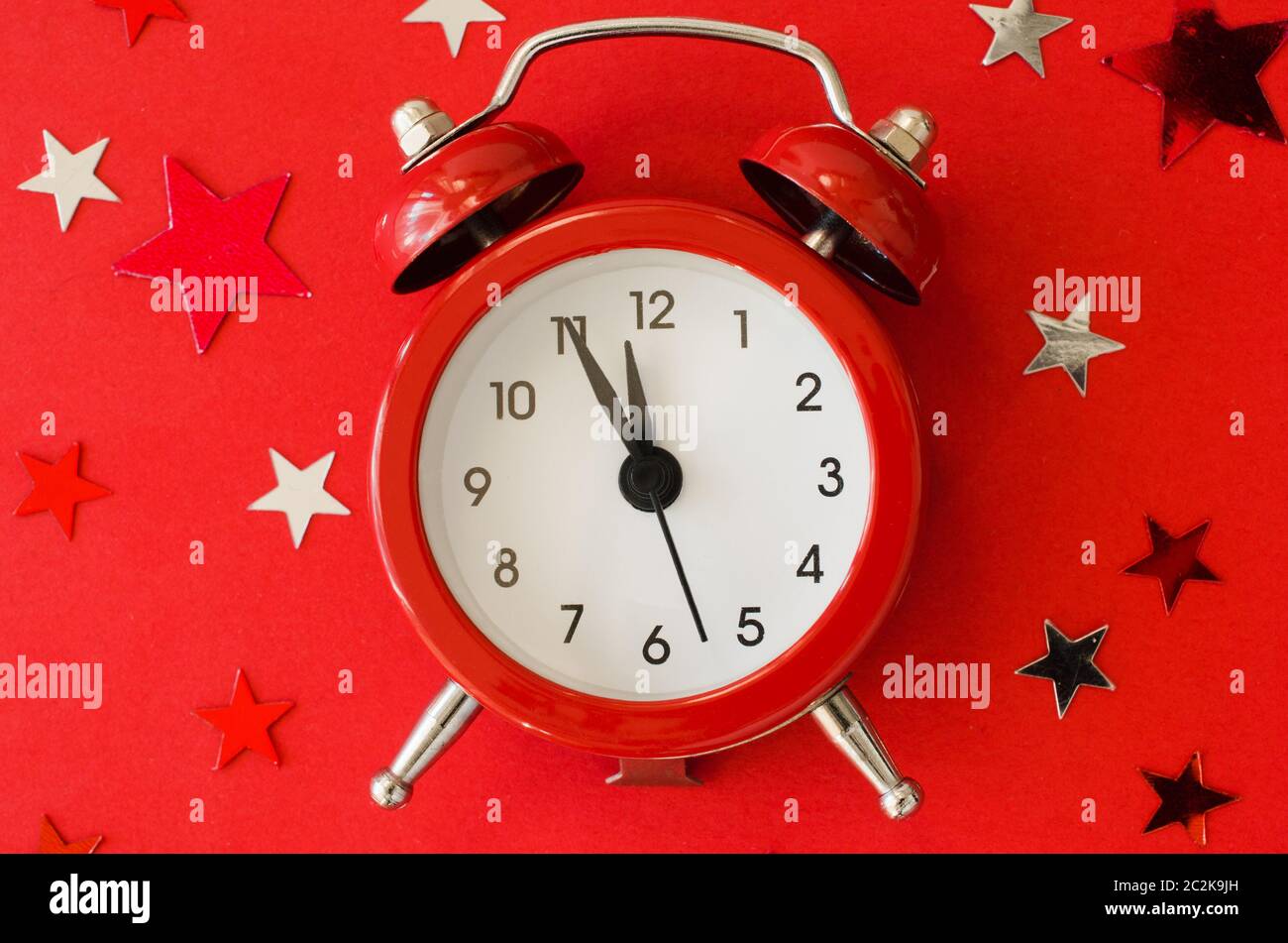 Festive Christmas background with alarm clock on red background in ...