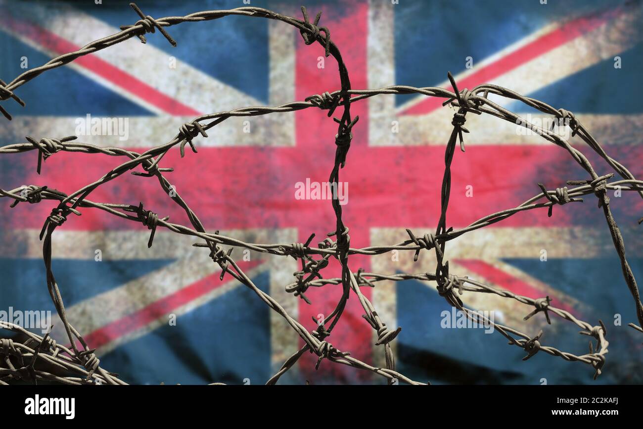 barbed wire in front of an old stained dirty union jack british flag ...