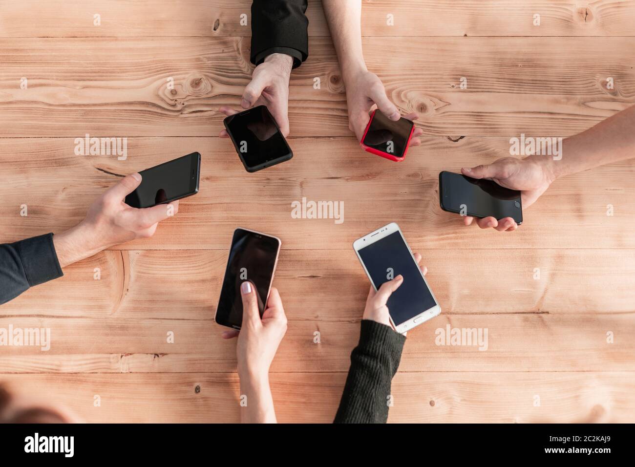 top view businessmen are holding mobile phones Stock Photo - Alamy