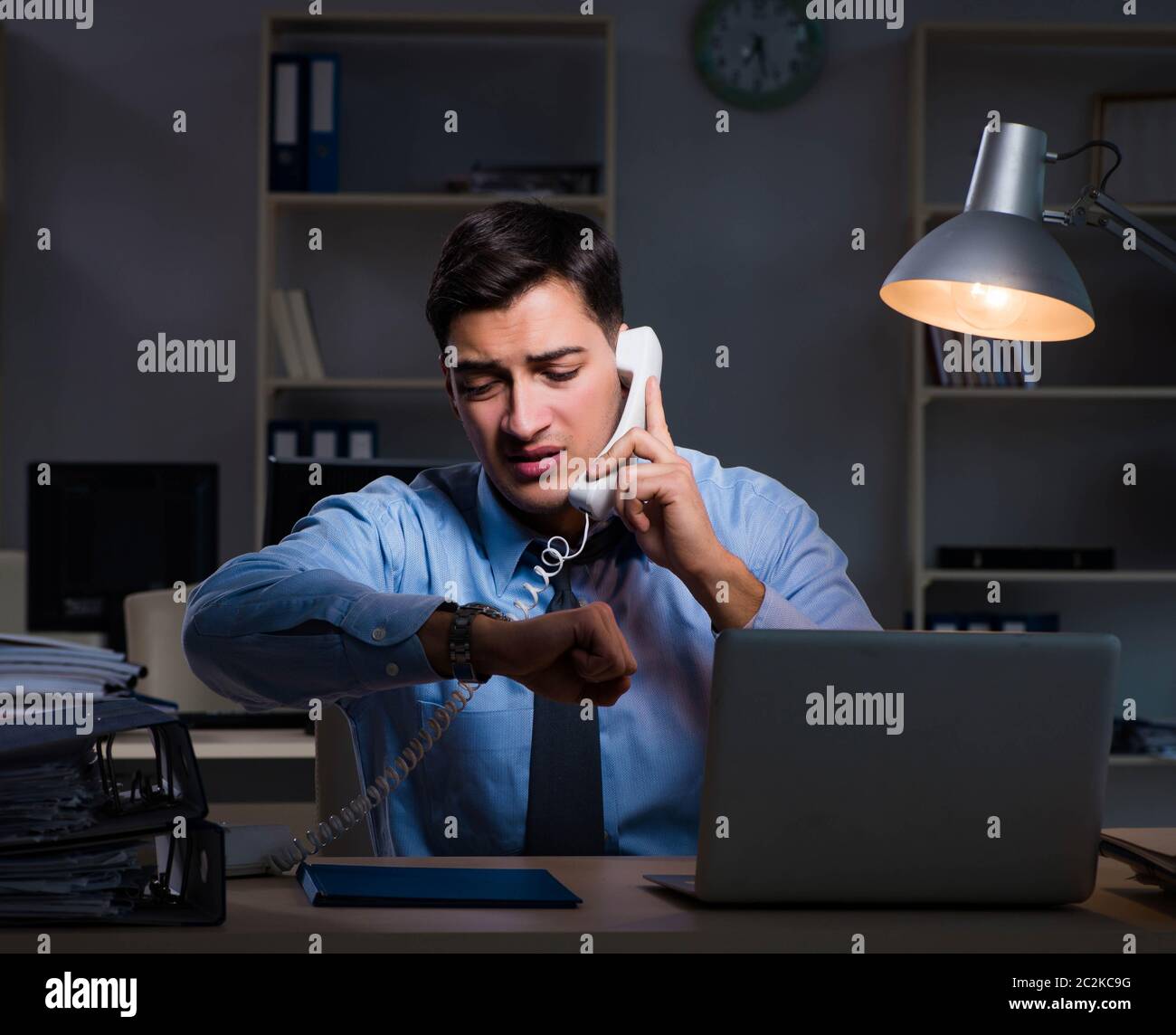 The employee working late at night at important report Stock Photo - Alamy