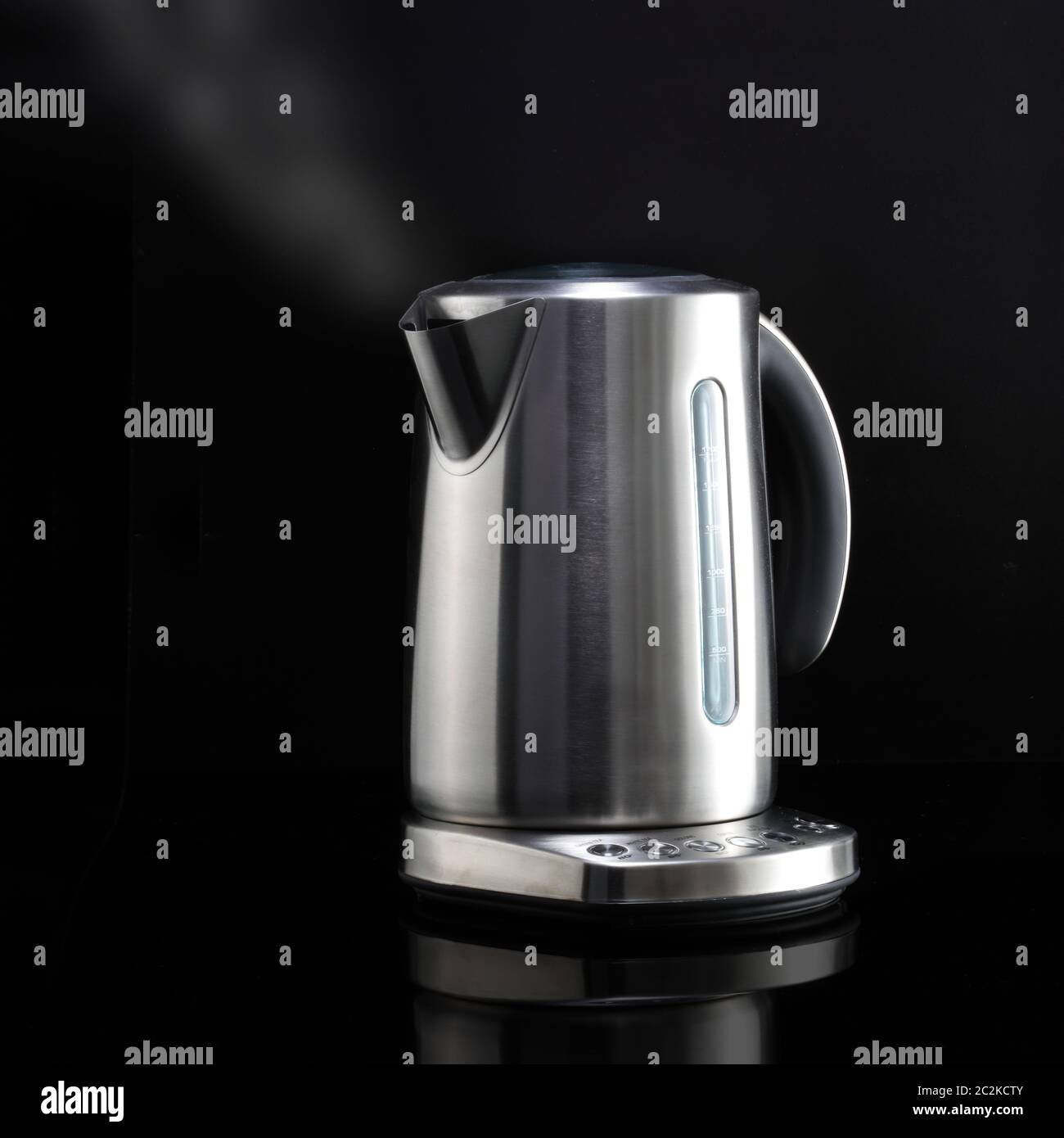 A modern kettle with steam on black reflective surface Stock Photo - Alamy