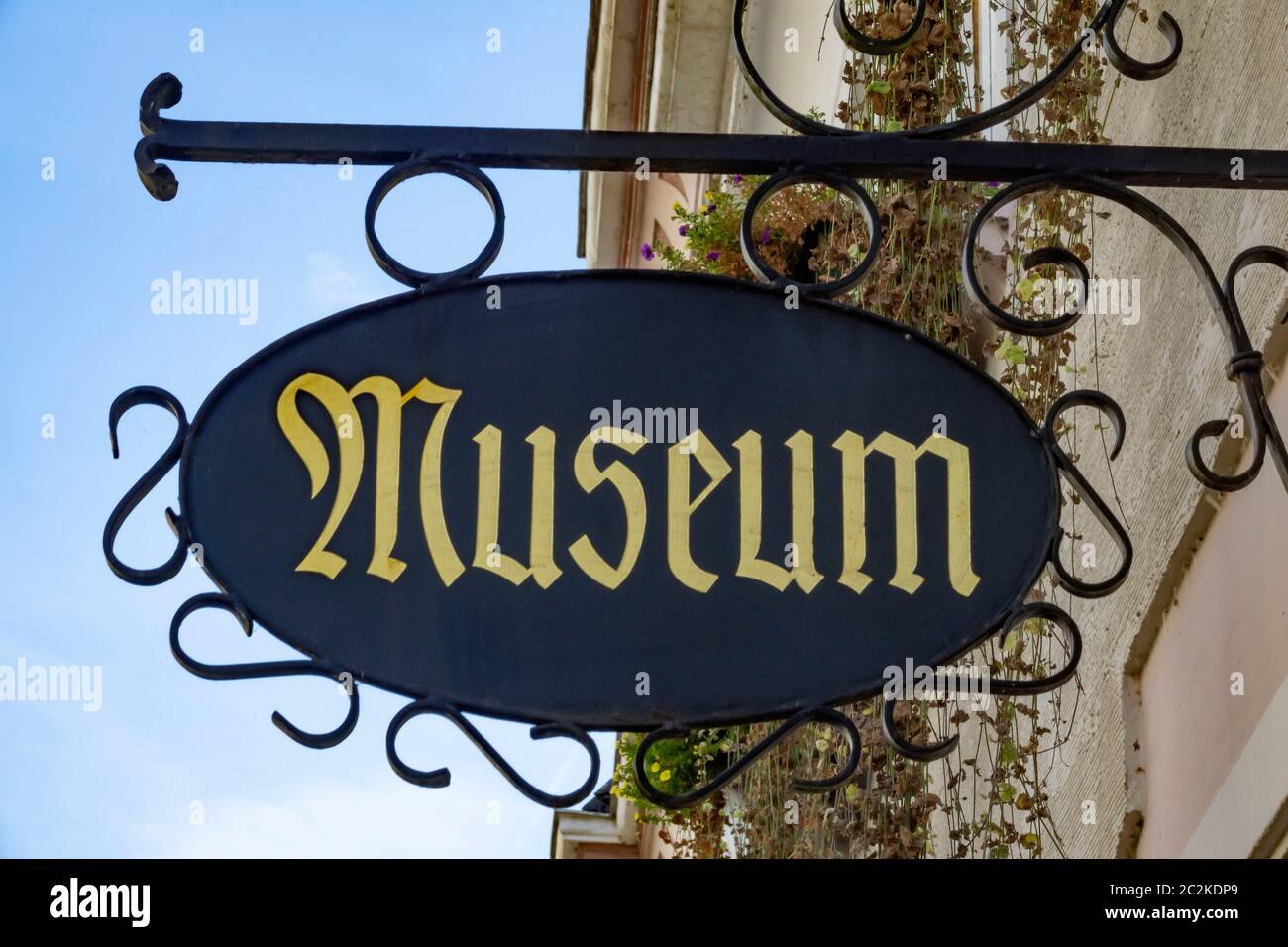 Beautiful black metal Museum Sign hanging on a facade Stock Photo - Alamy