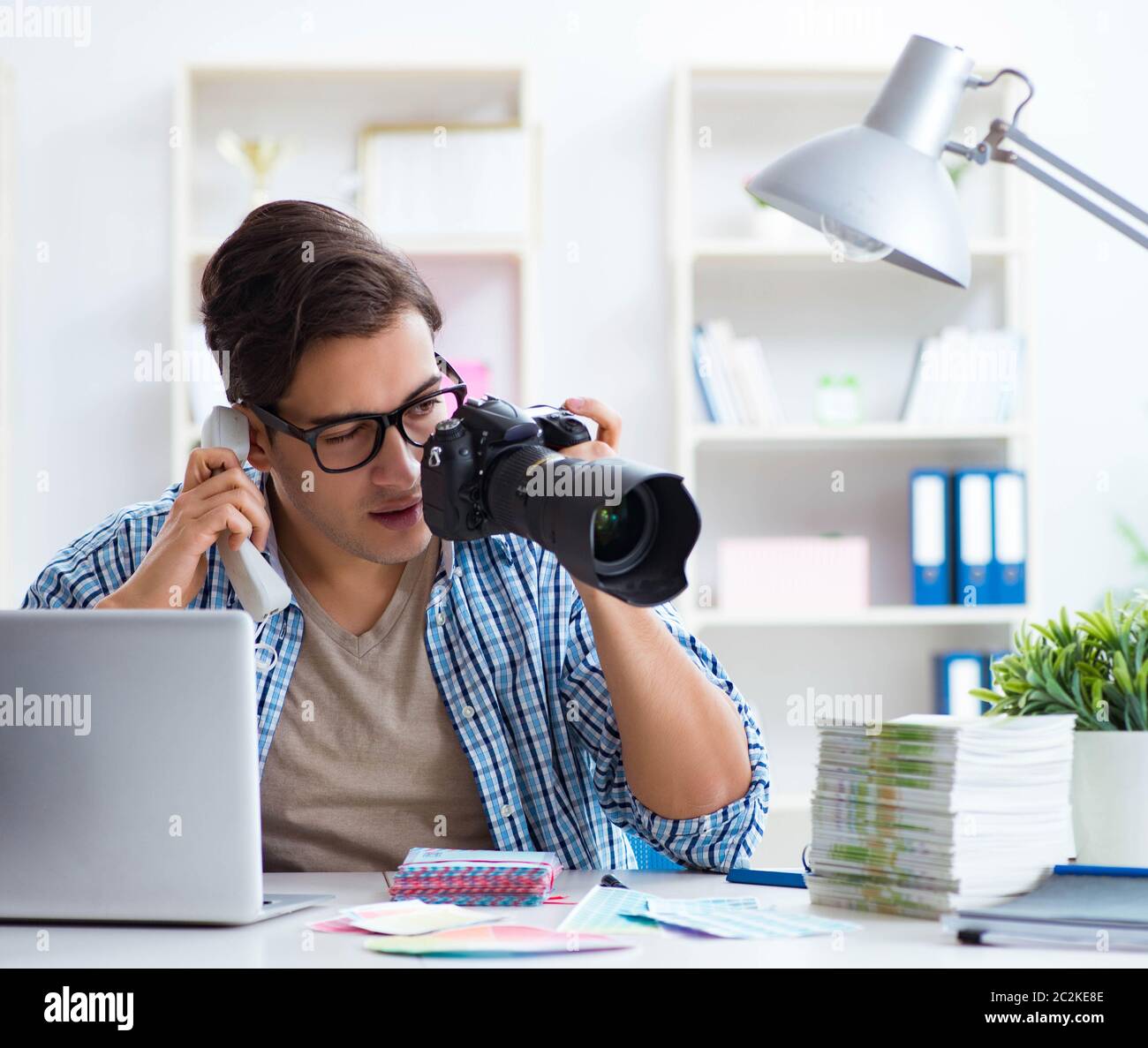 The young photographer working with his camera Stock Photo - Alamy