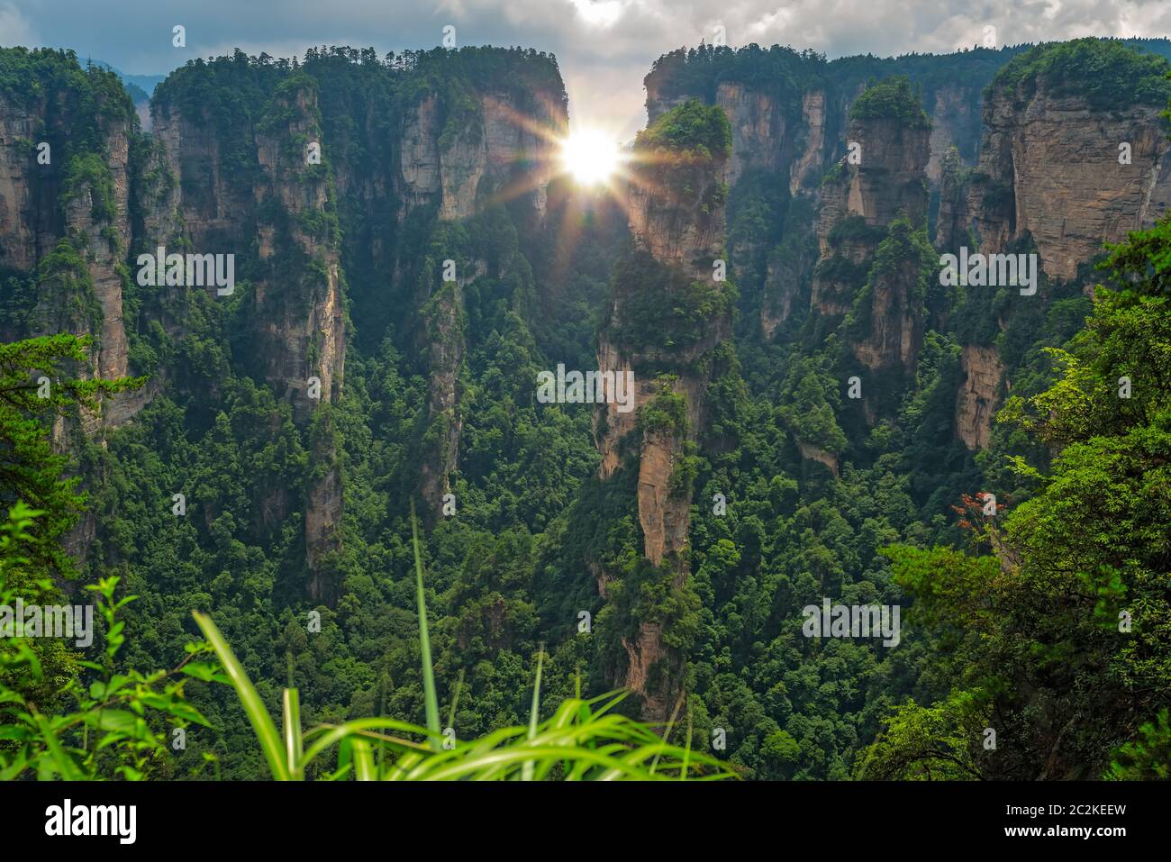 Sun shining through the vertical karst pillar rock formations as seen ...