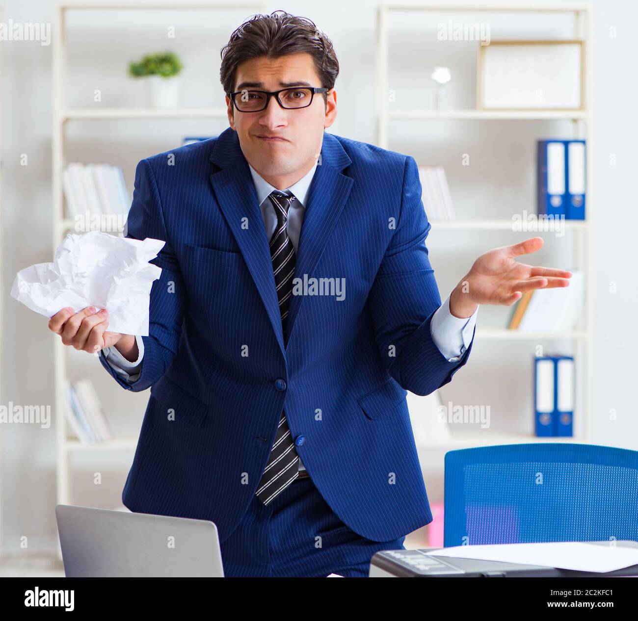 The businessman angry at copying machine jamming papers Stock Photo - Alamy