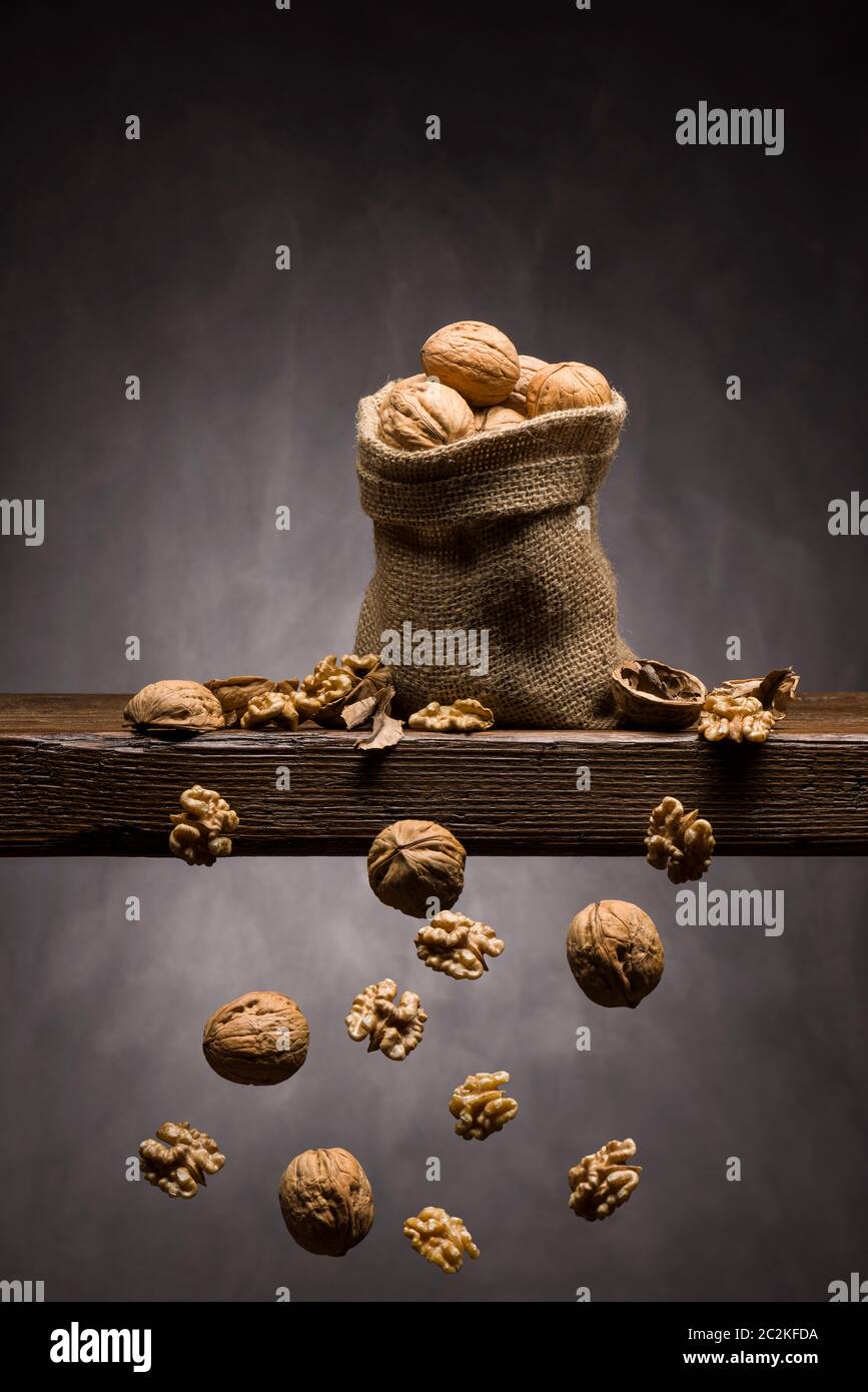 Walnuts falling on wooden table hi-res stock photography and images - Alamy