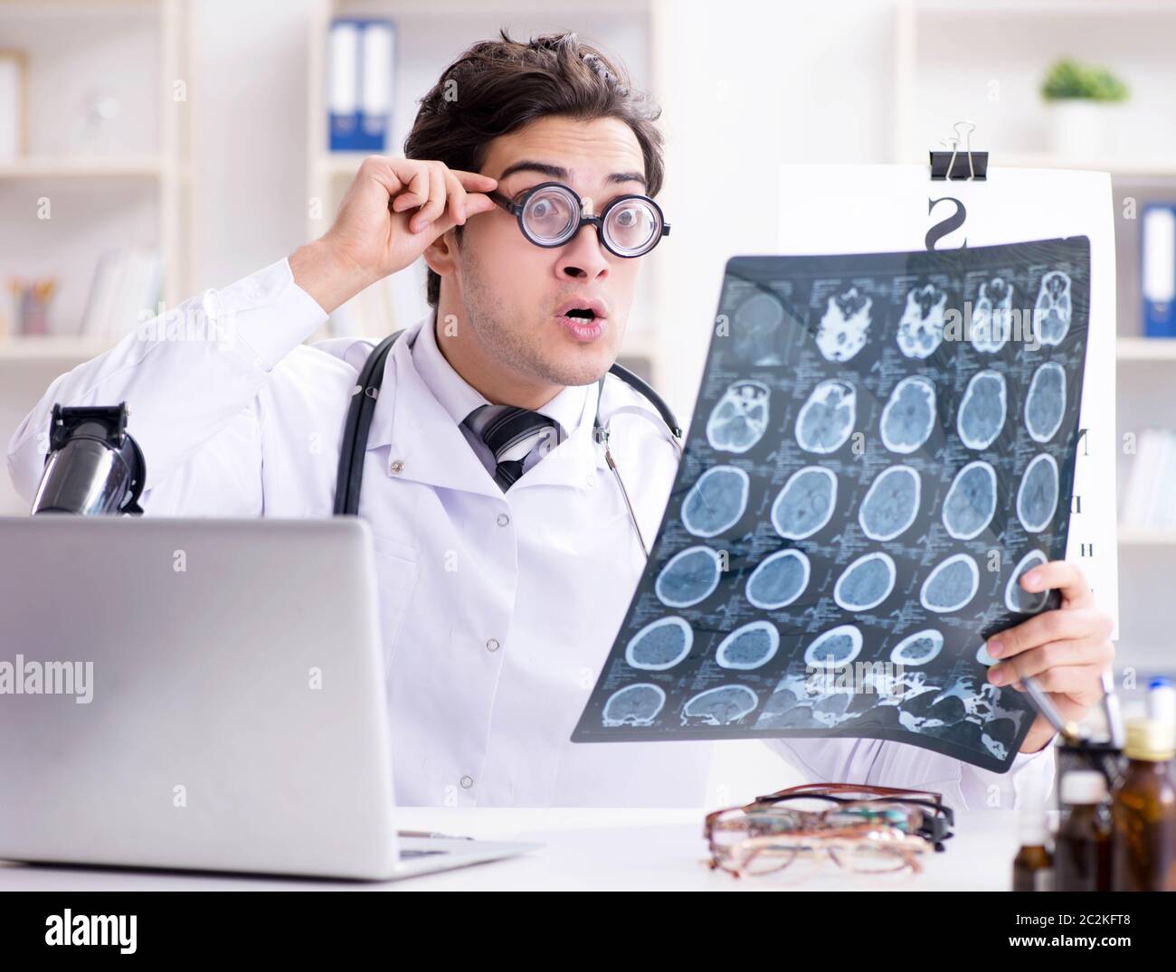 The funny eye doctor in humourous medical concept Stock Photo - Alamy