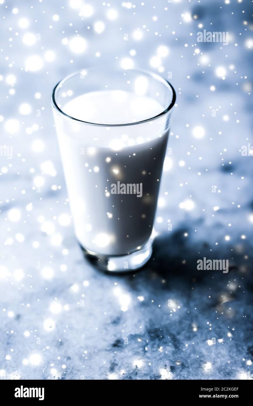 Magic holiday drink, pouring organic lactose free milk into glass on ...