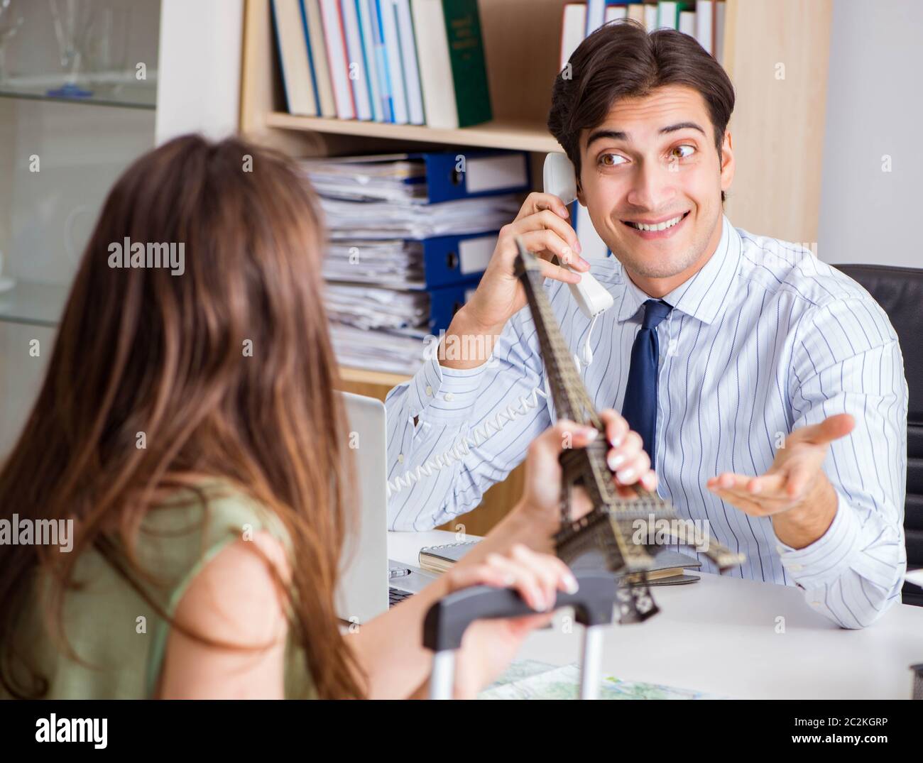 The customer visiting travel agency and talking to agent Stock Photo ...