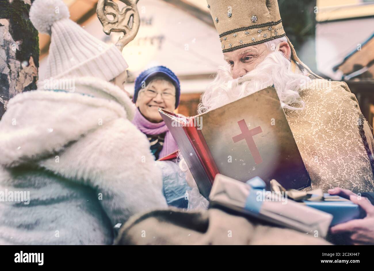 St Nicholas reading stories from the Bible to a child Stock Photo - Alamy
