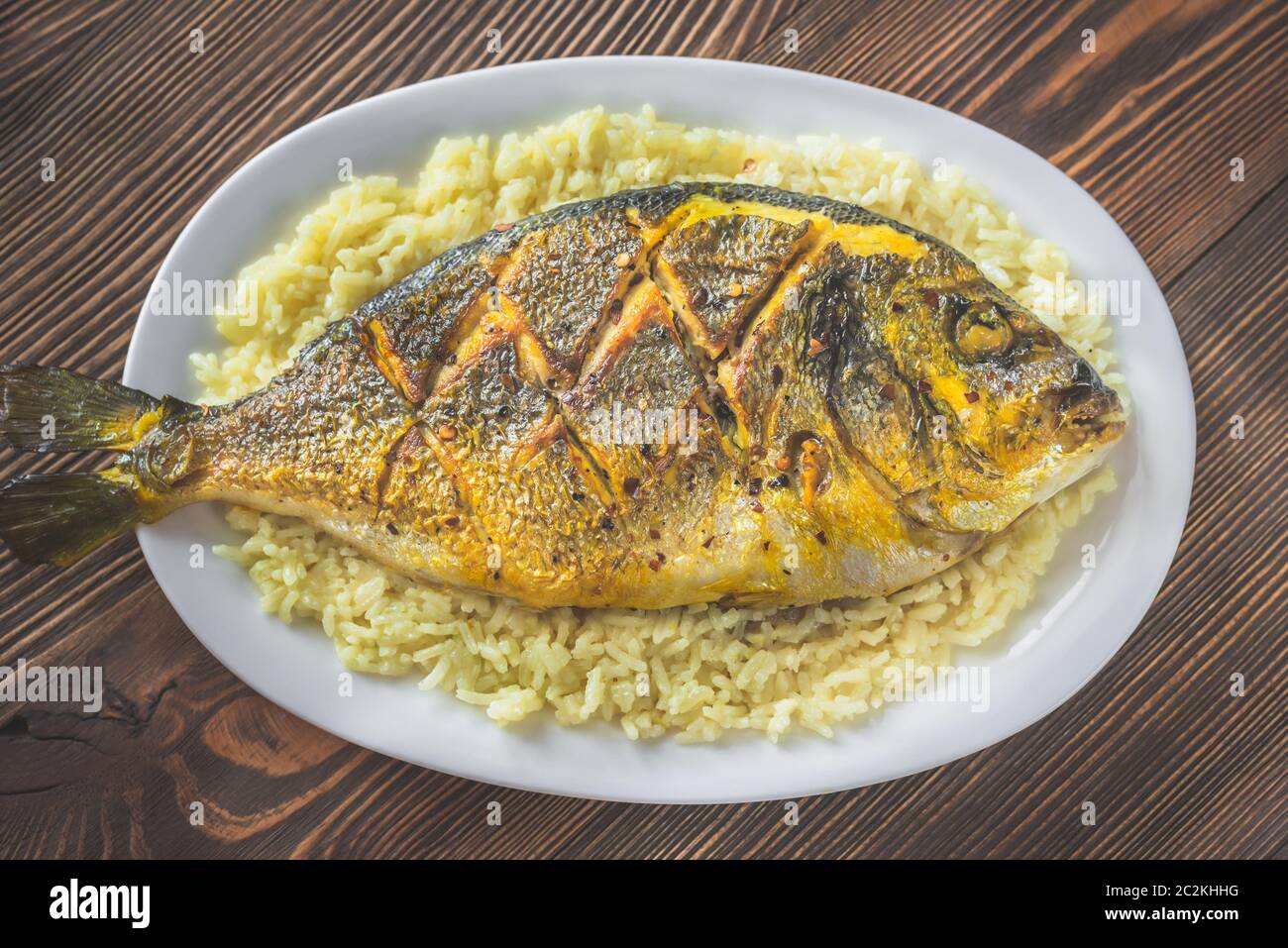 Fried saffron sea bream with curry rice Stock Photo - Alamy