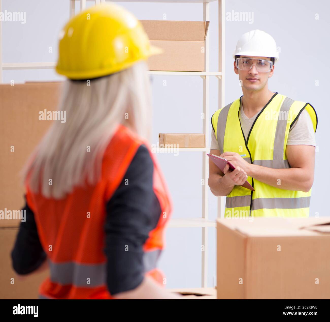 The delivery contractor delivering boxes to office Stock Photo - Alamy