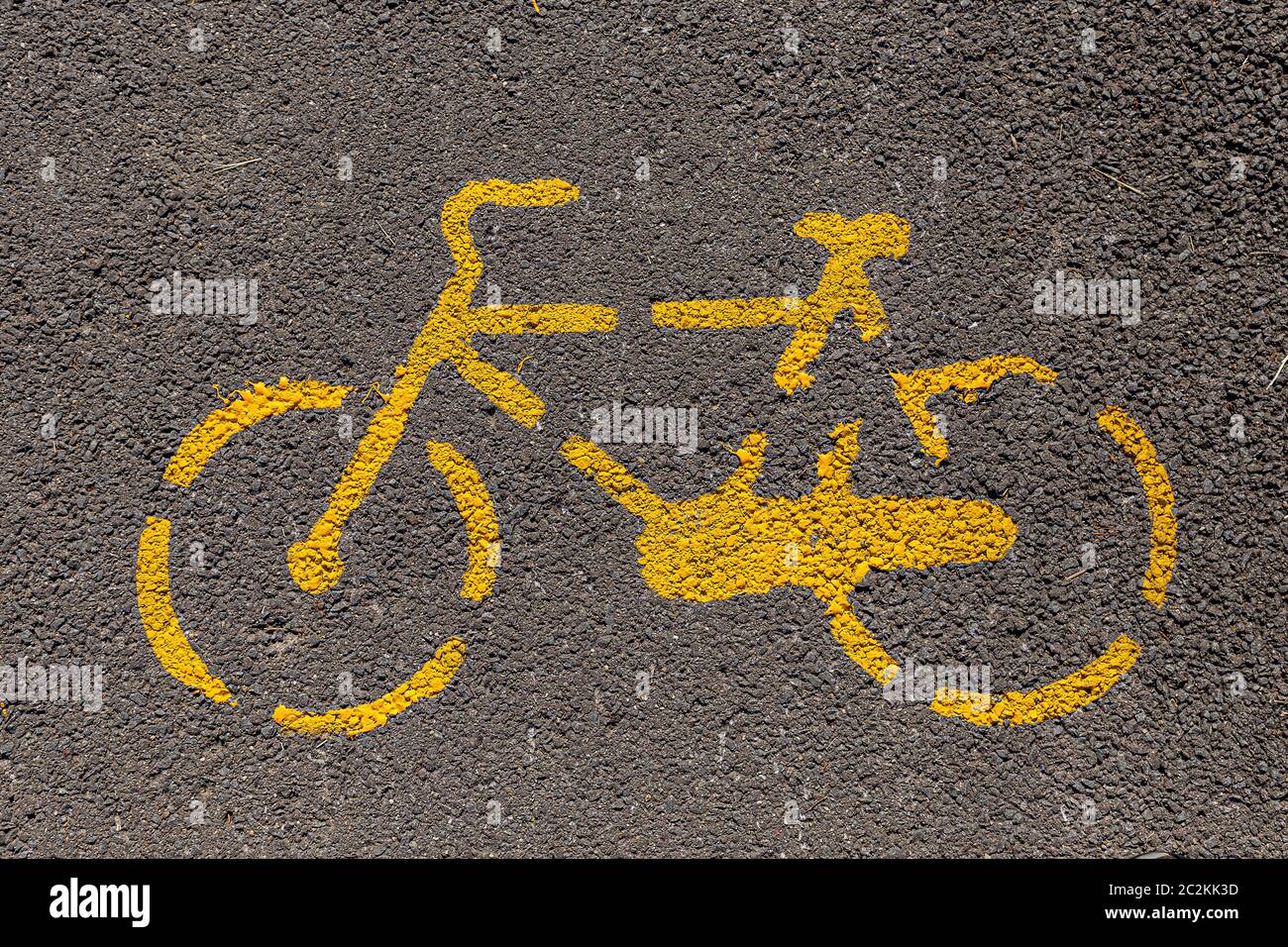 Yellow bicycle road marking on asphalt surface Stock Photo - Alamy