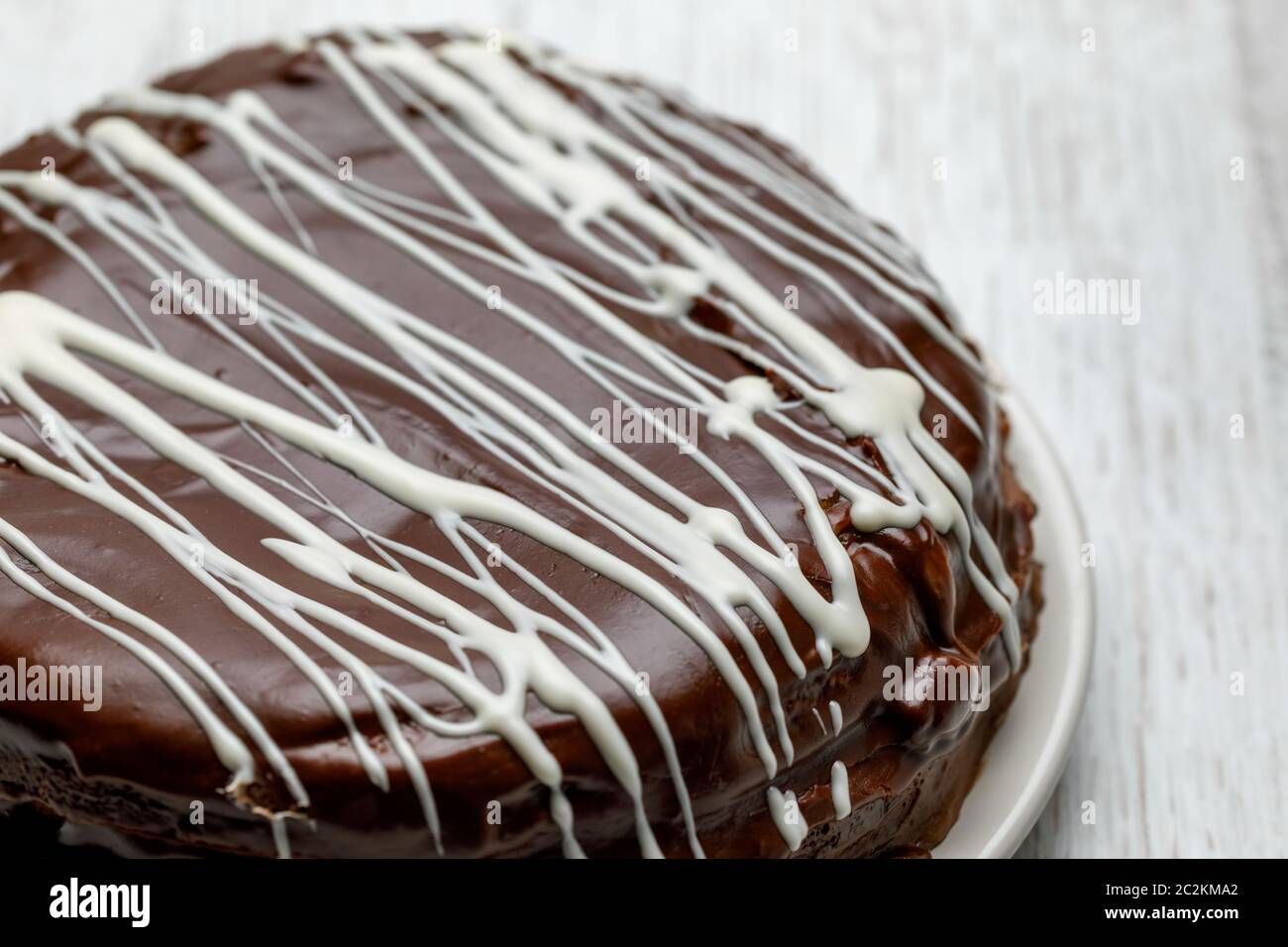 Homemade chocolate cake with chocolate glaze with white stripes on ...