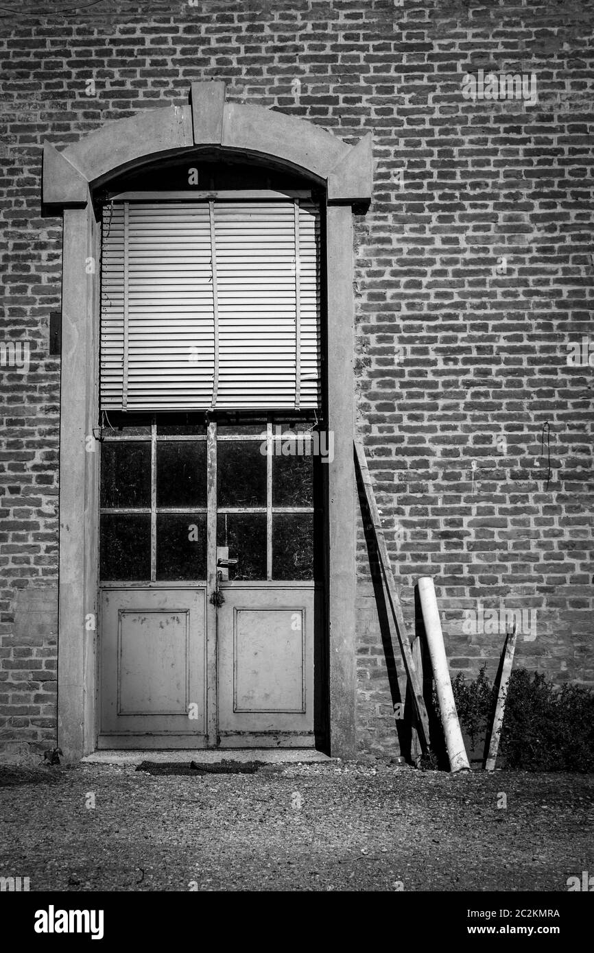Detail of a door of a very old abandoned building. A symbol of fear and ...