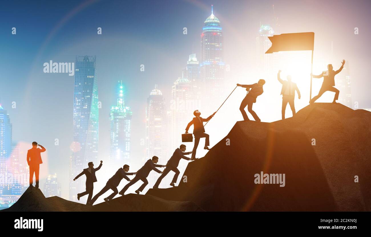 Concept of teamwork with team climbing mountain Stock Photo - Alamy