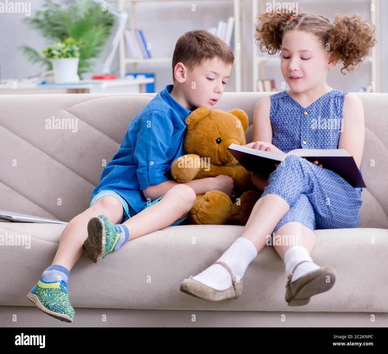 The two kids reading books at home Stock Photo - Alamy