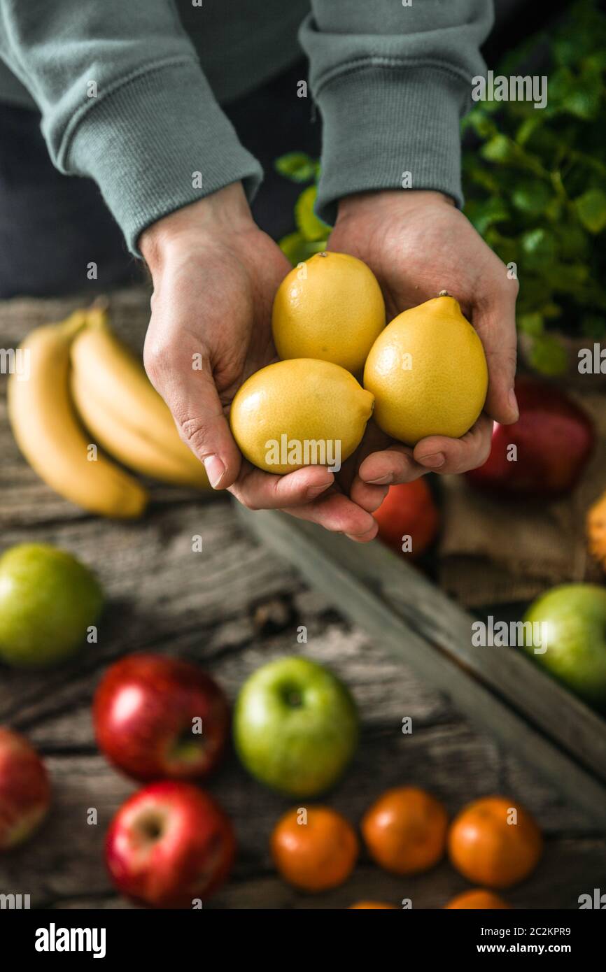 Organic fruit on wood. Farmer holding harvested fruit and vegetables. Rustic setting Stock Photo ...
