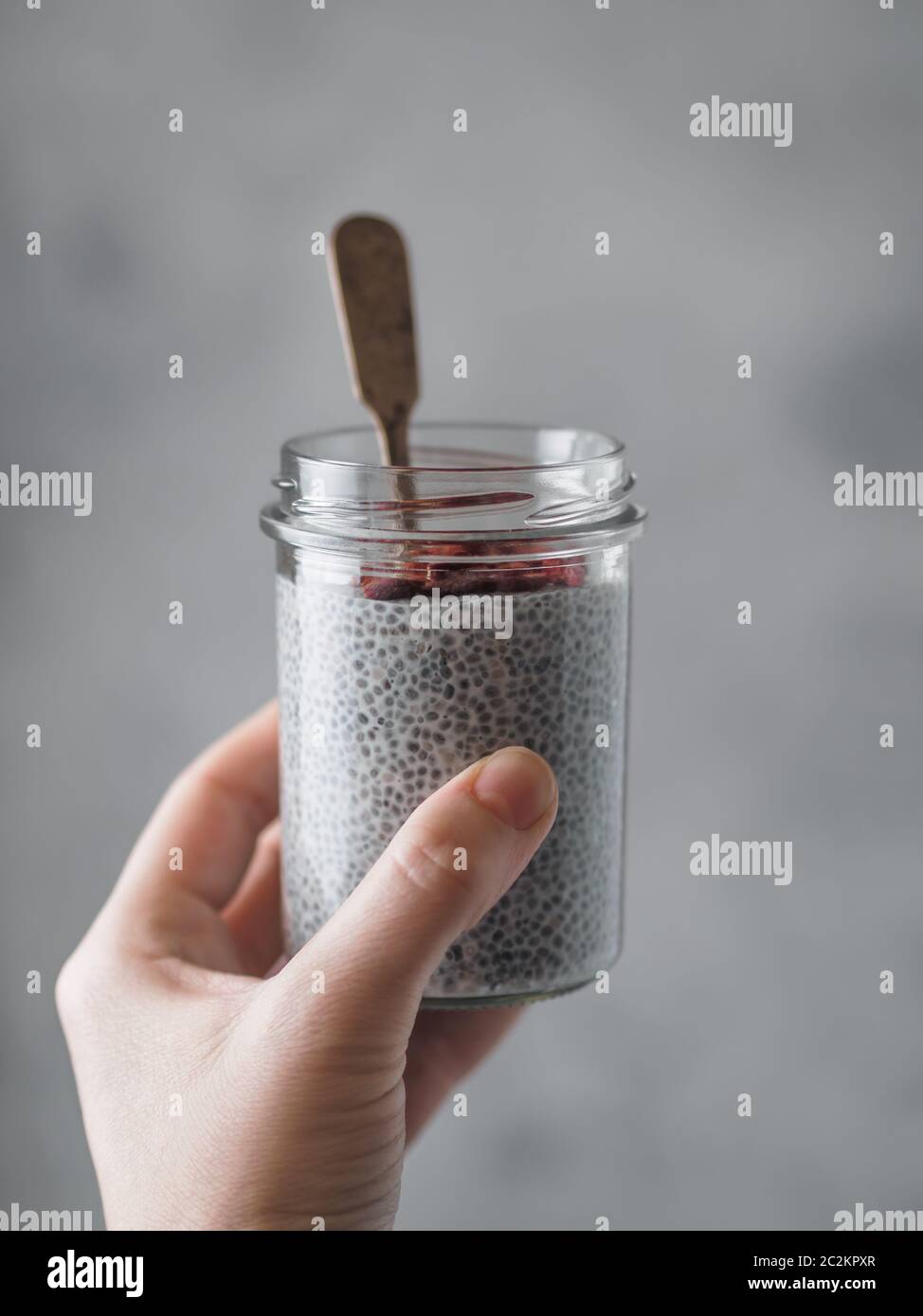 Chia pudding in woman hand Stock Photo - Alamy
