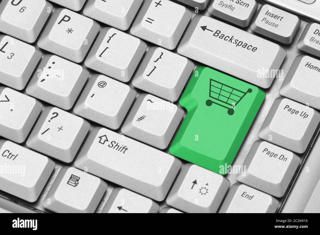 a computer keyboard with shopping cart key in green Stock Photo - Alamy