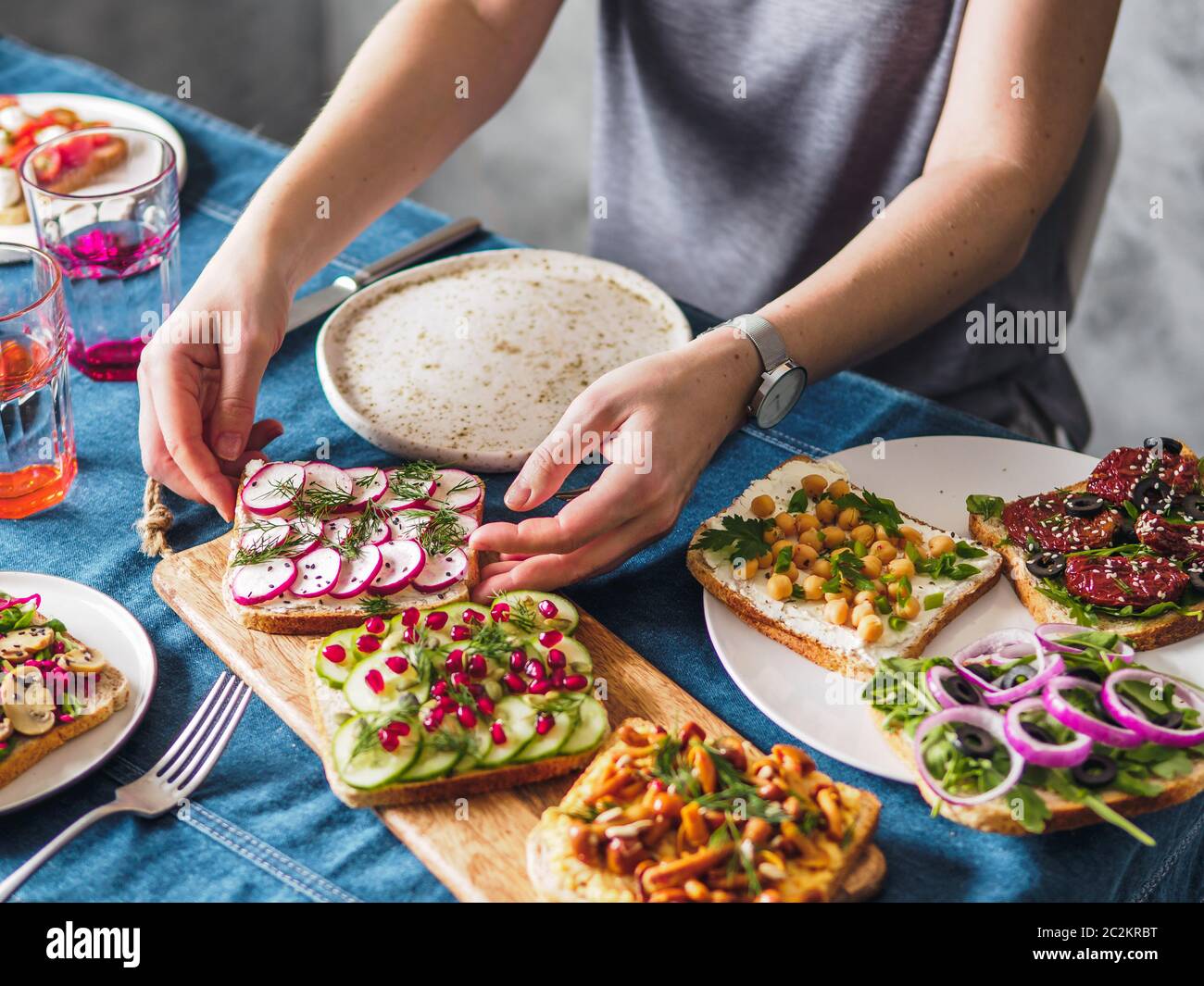 Female hands on vegetarian tablesettings Stock Photo - Alamy