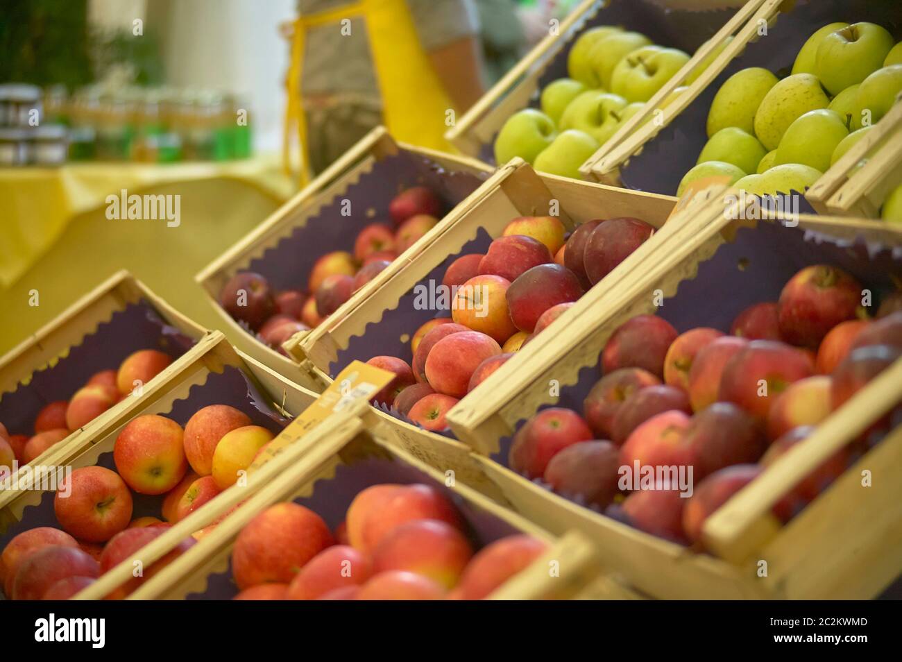 Apples boxes of various qualities and colors in display at the market ...