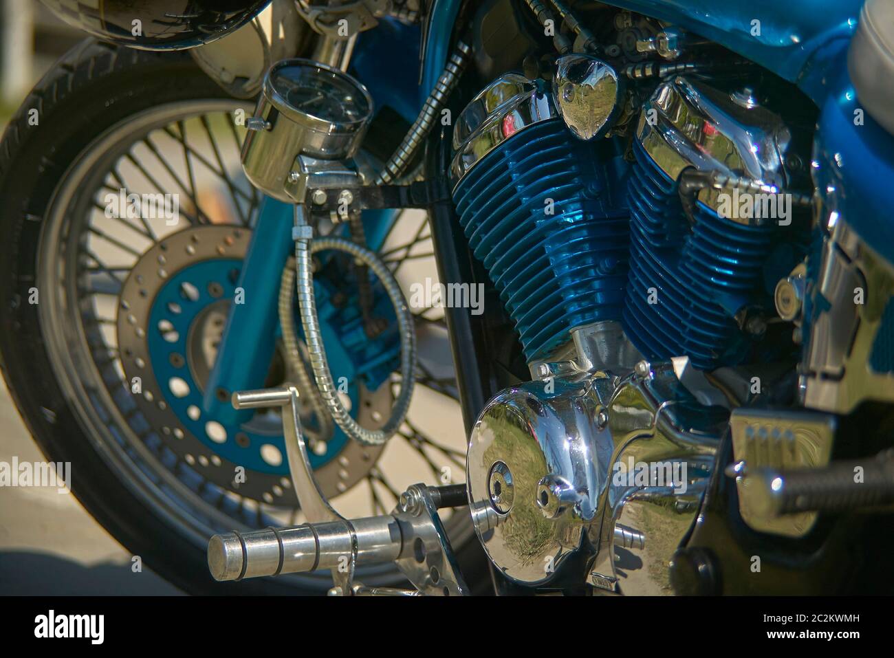 Engine of a colorful custom blue motorcycle, with glittering chromes, a ...