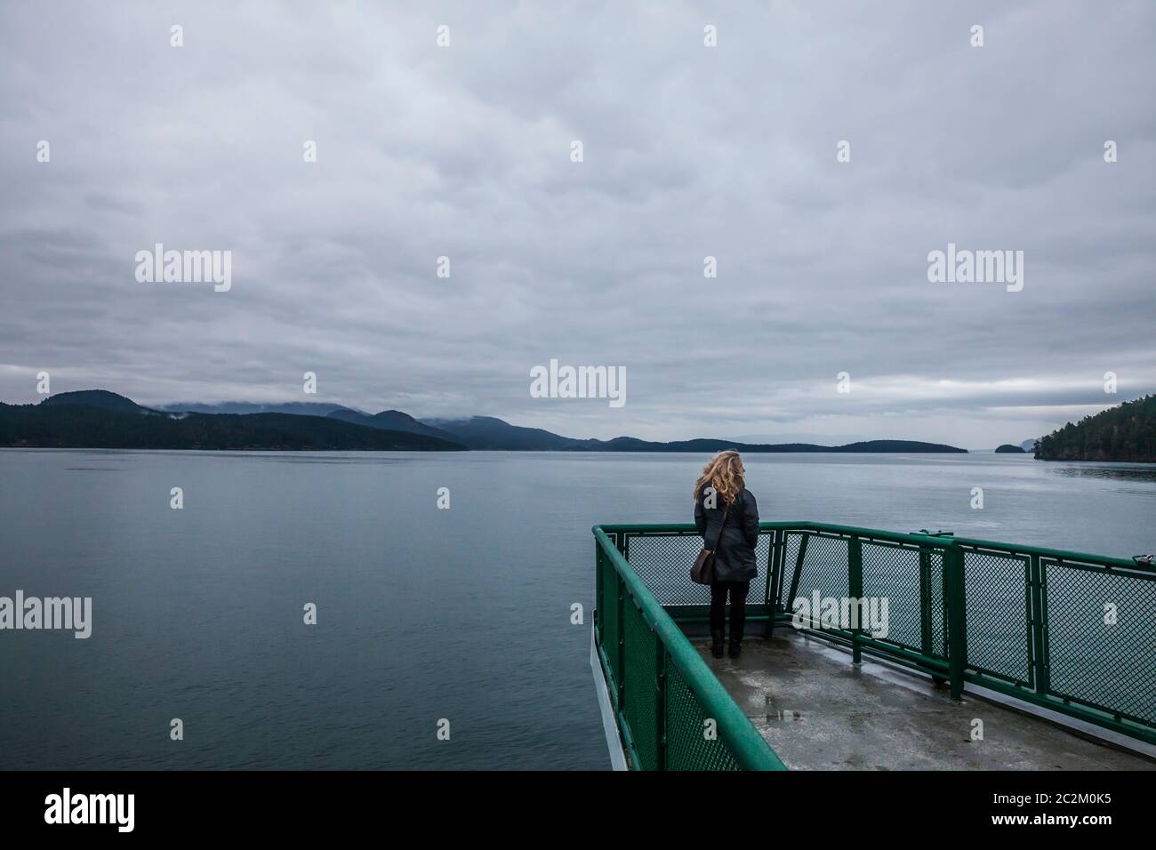 A woman stands on the observation deck on a Washington State Ferry as ...