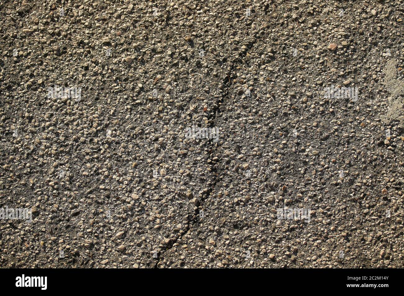 Texture of the worn and ruined asphalt with a crack in the middle Stock ...