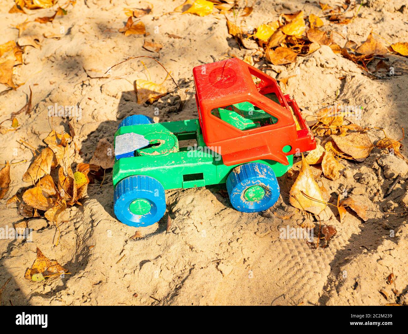 Children's plastic toy lorry in the sand. Children's games Stock Photo ...
