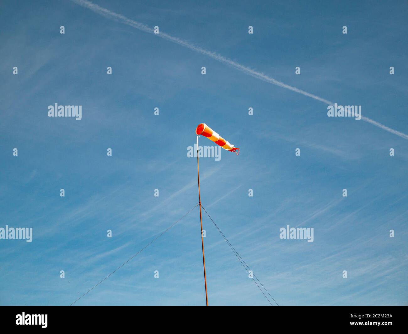 Wind direction indicator on the airfield. Navigation. Blue sky Stock ...