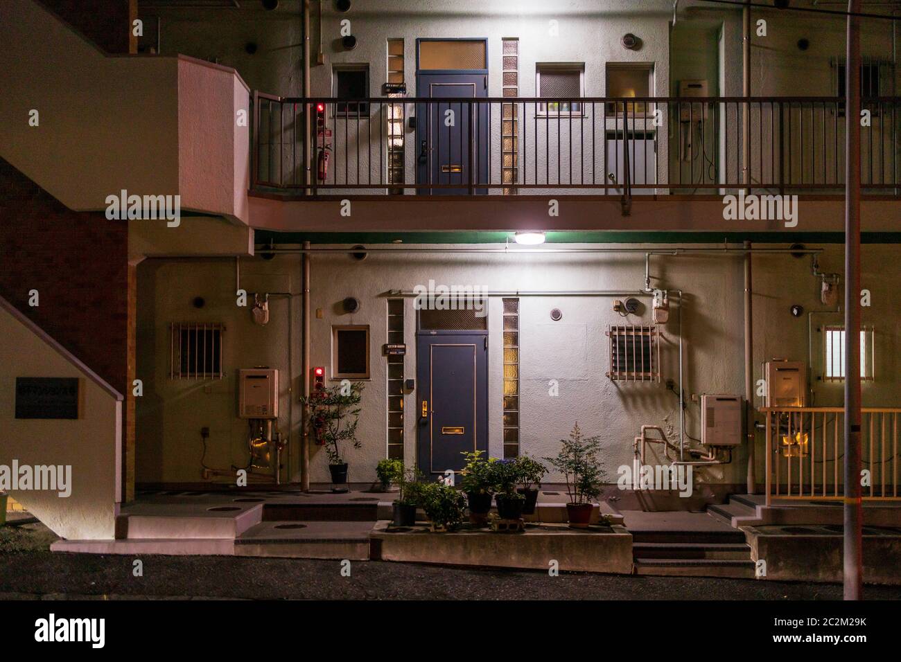 Blue front doors on 2-story Japanese rental apartment building at night ...