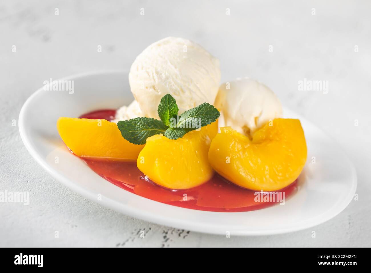 Peach Melba - dessert of peaches and raspberry sauce with vanilla ice ...