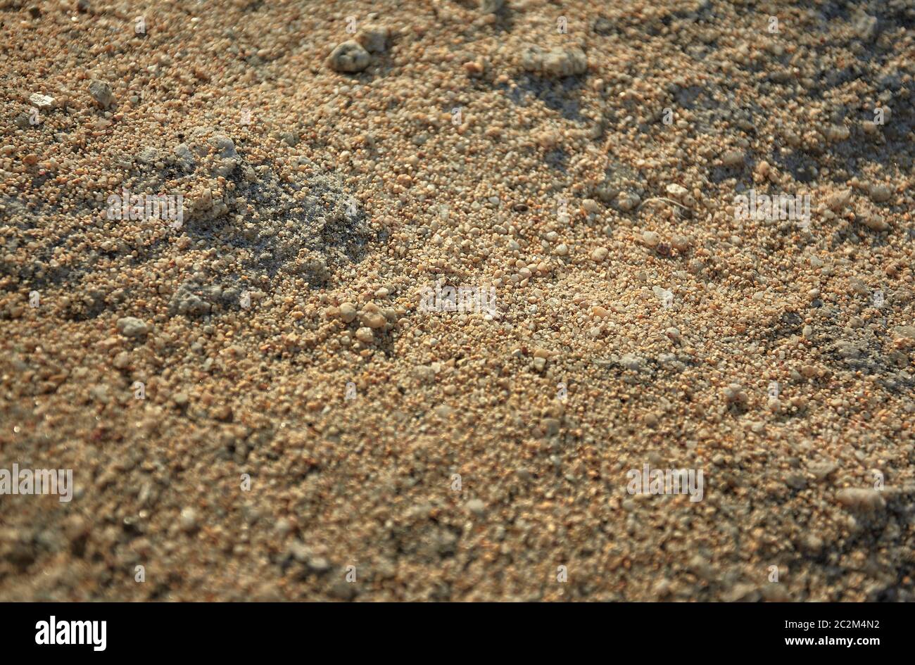 Texture of fine Mediterranean sand with some pebbles shot during the ...
