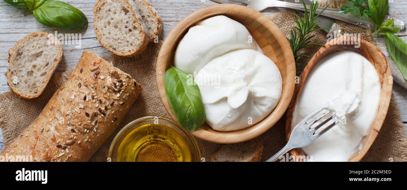 Italian cheese burrata, olive oil and bread top view Stock Photo - Alamy