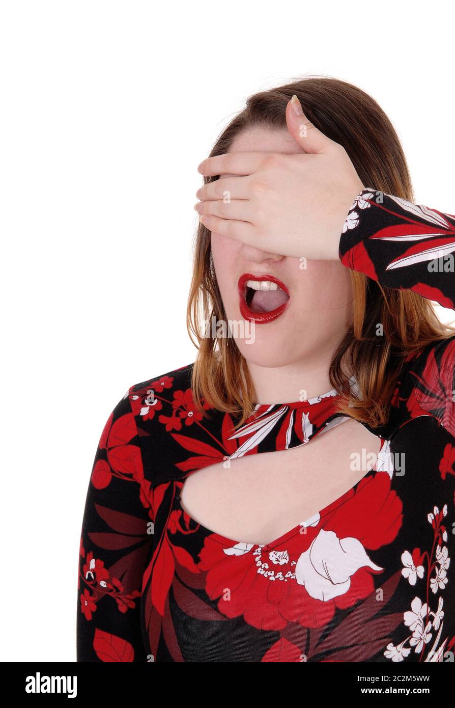 A young gorgeous woman standing in the studio for white background ...