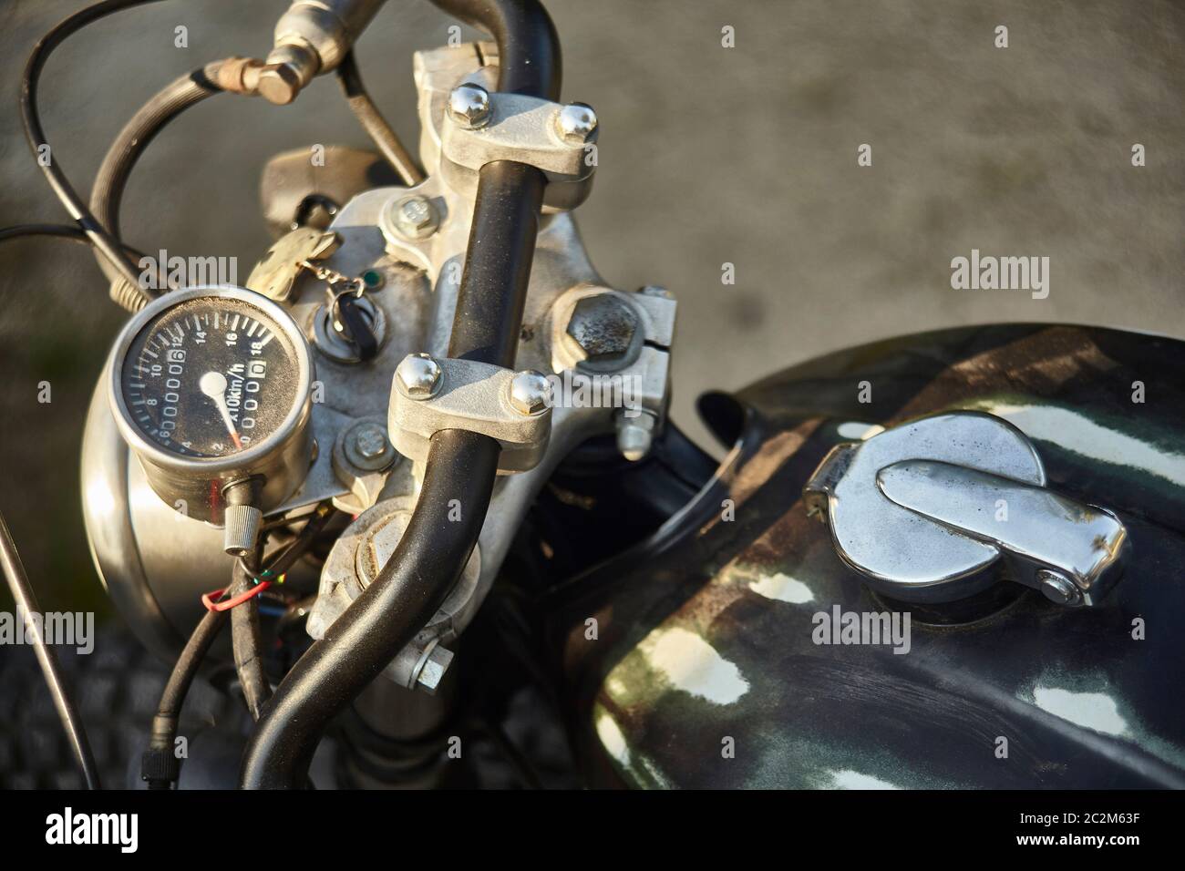 Detail of the handlebars and the speedometer of a vintage black ...