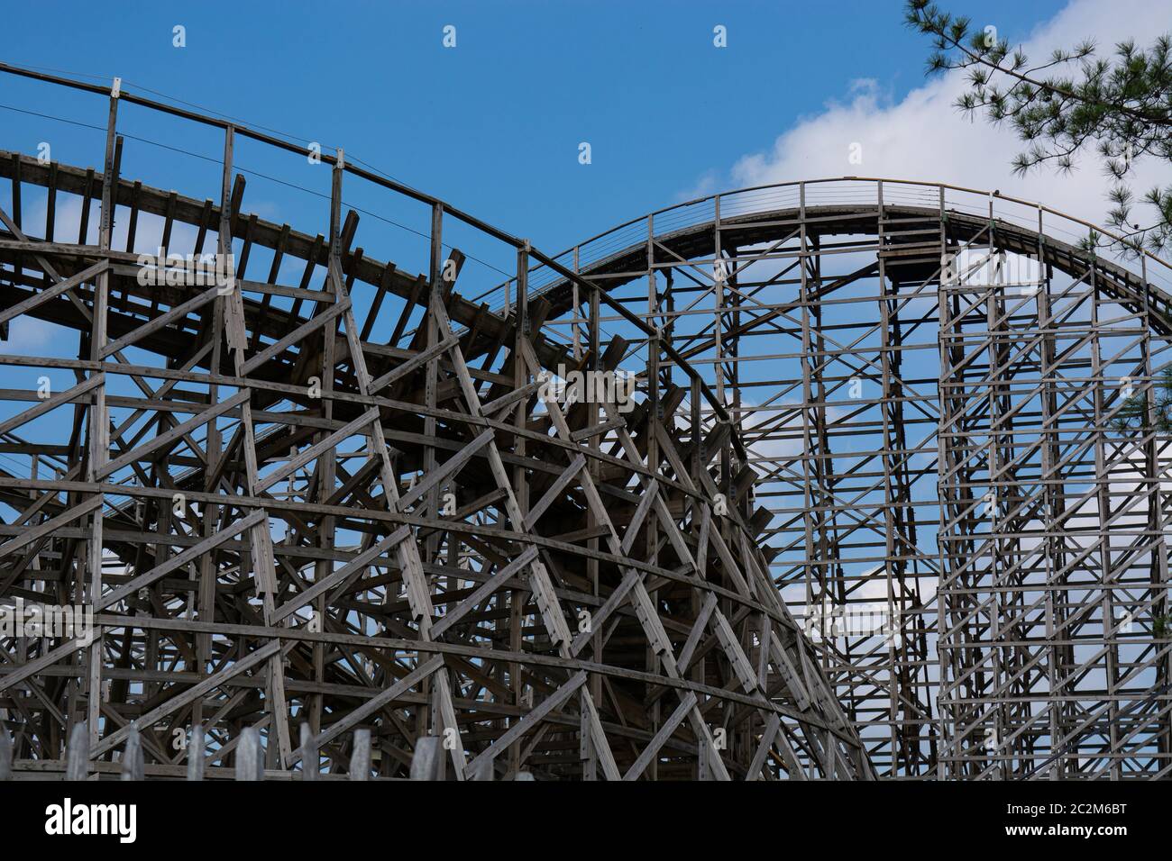 Roller coaster in an amusement park without a car in front of blue sky ...