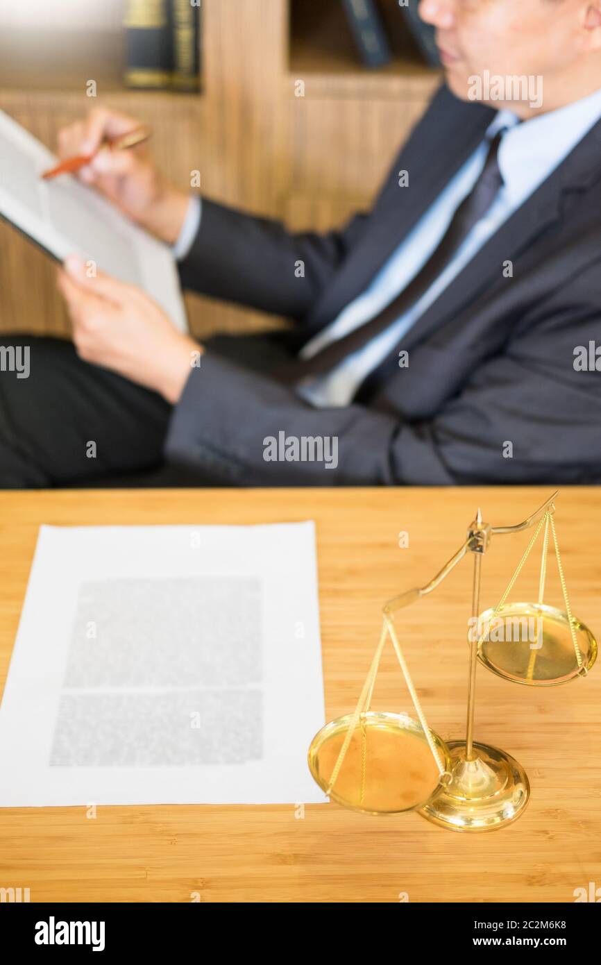 lawyer judge reading documents at desk in courtroom working on wooden ...