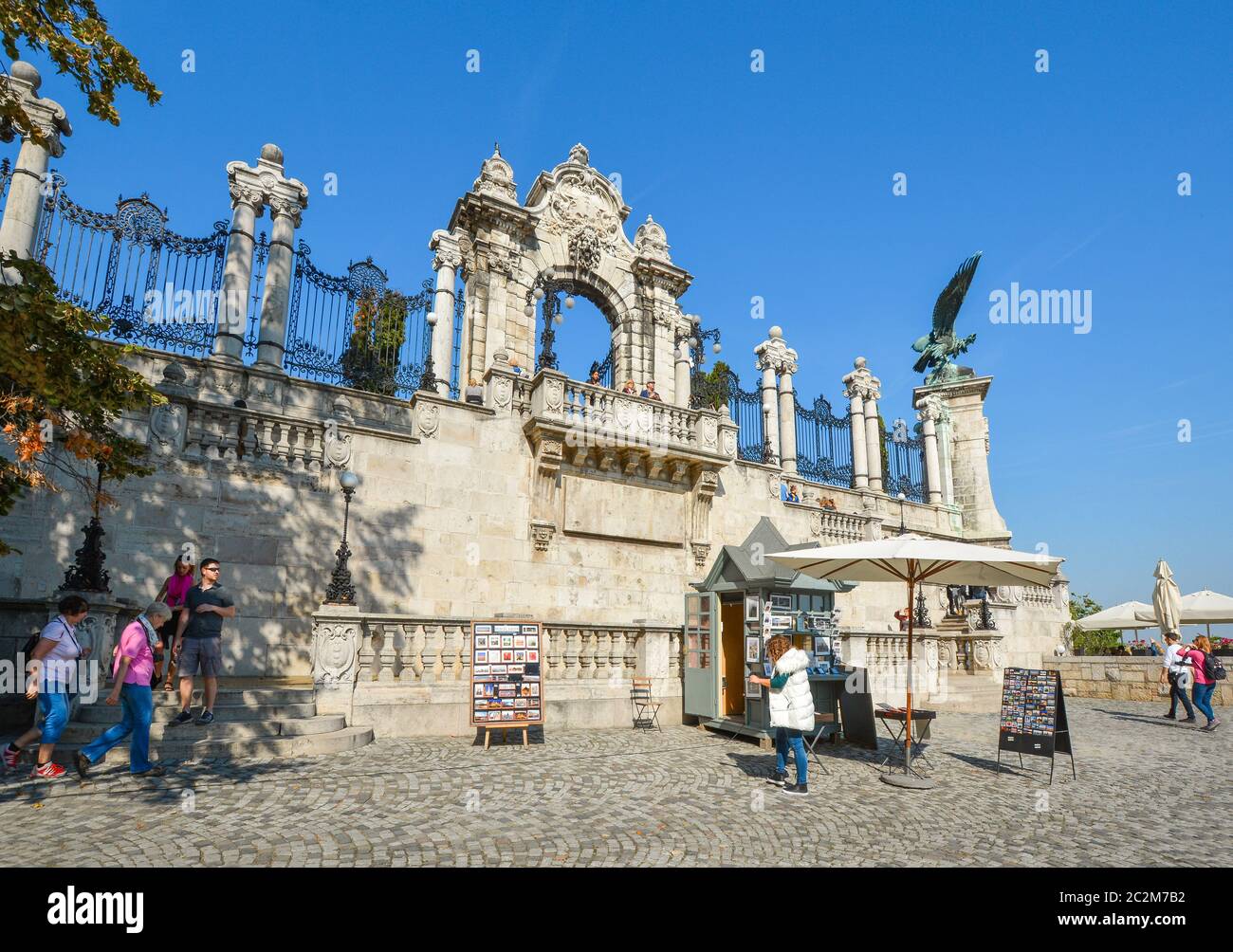 A souvenir vendor sells prints under the Turul statue at the Buda ...