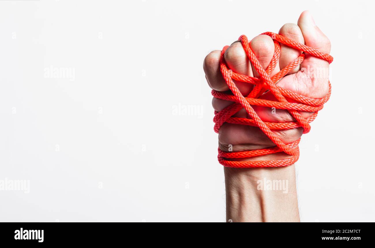 Red Rope on fist hand on white background, Human rights day concept ...