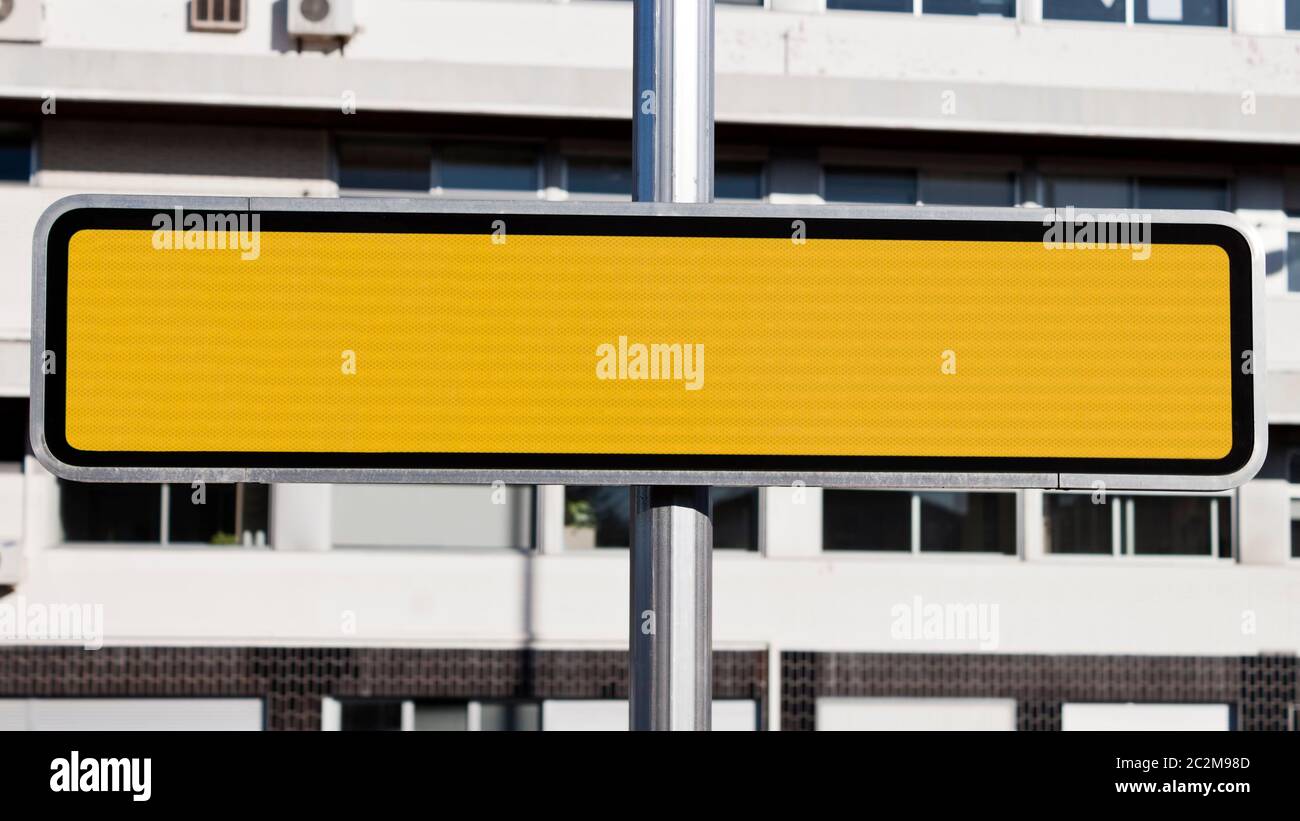 Blank yellow reflective road sign in the street. Empty traffic signal ...