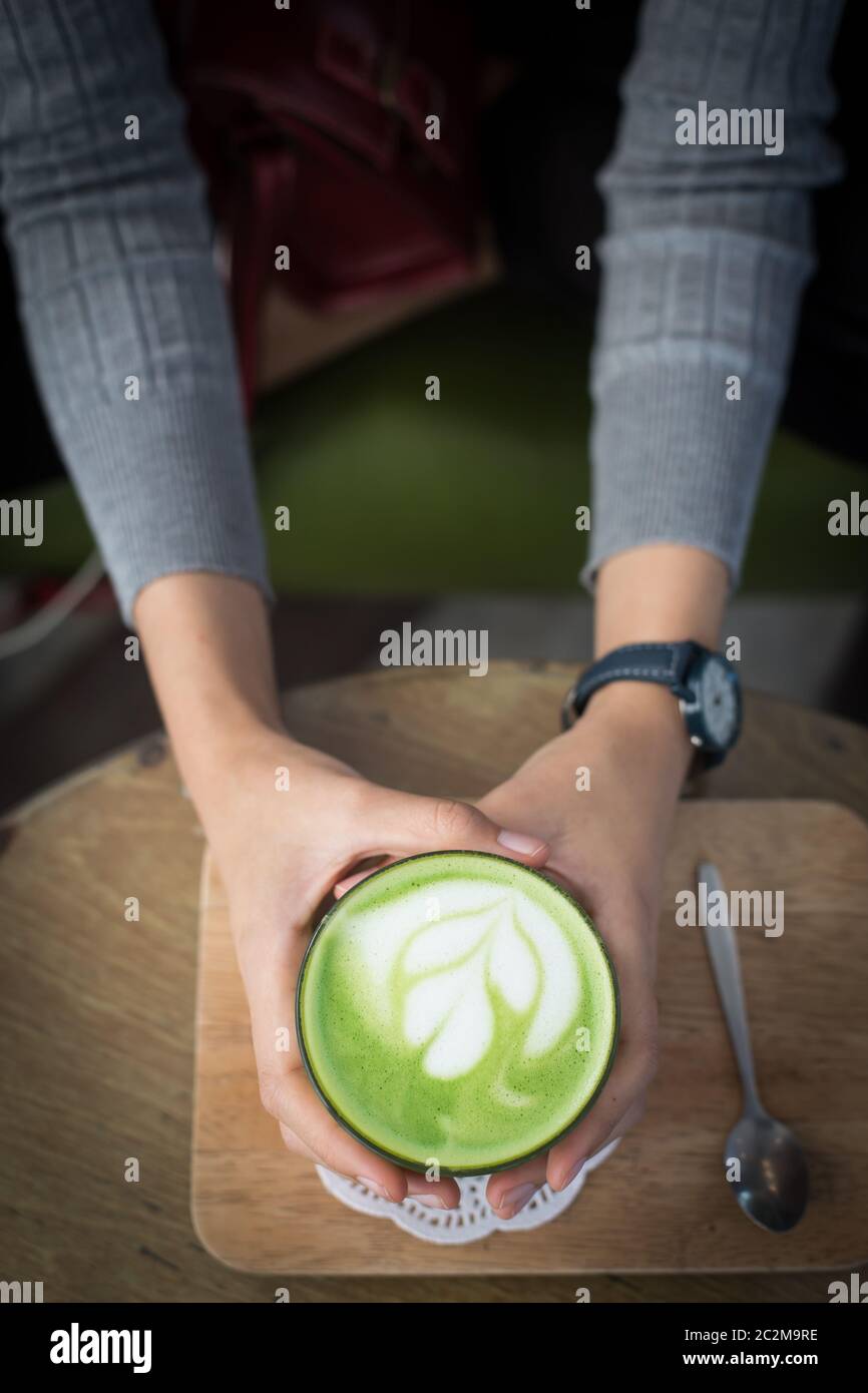 Cup of Matcha Green Tea in woman hand Stock Photo - Alamy